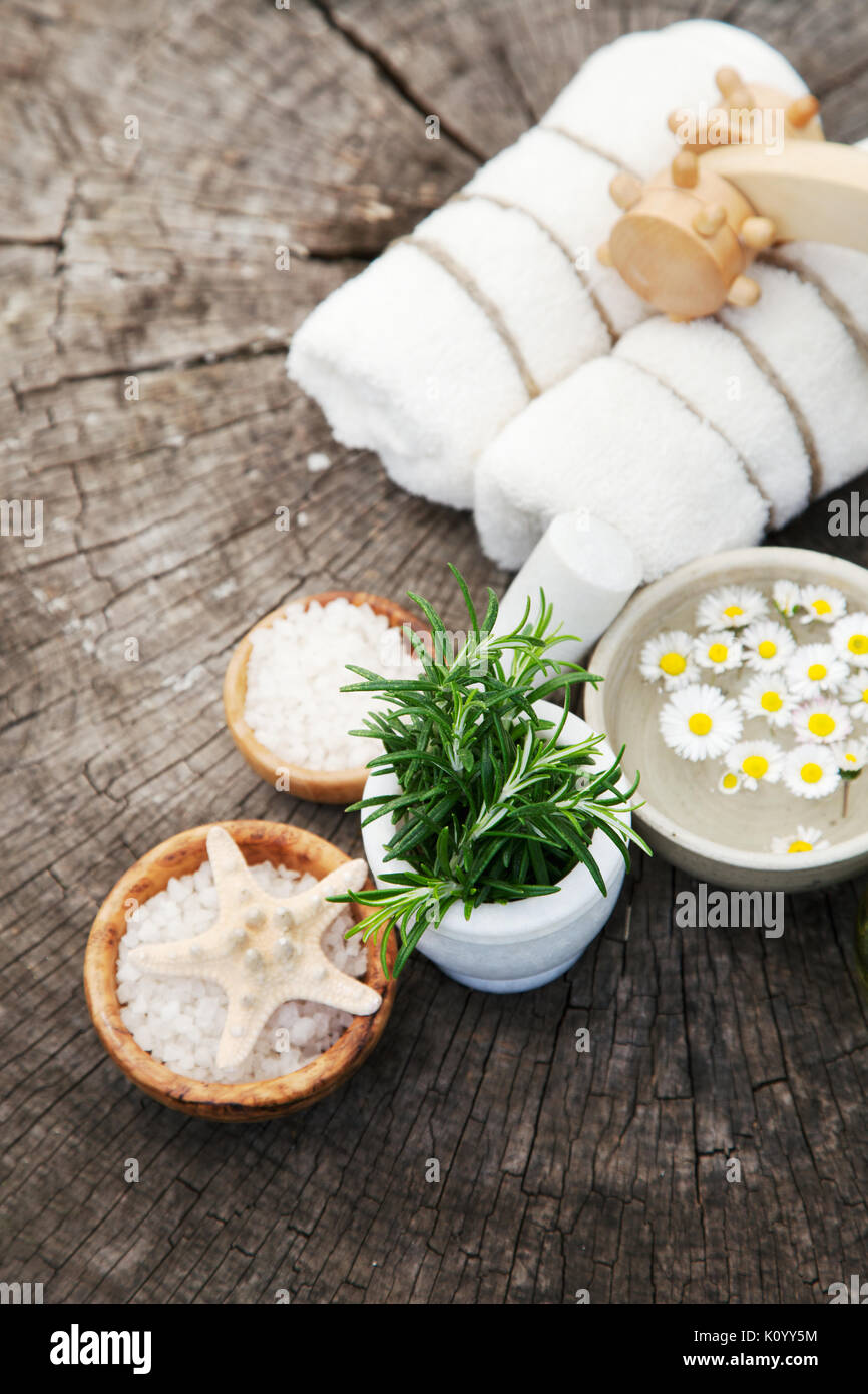 Spa and wellness setting with flowers, floral water and towel. Natural ...