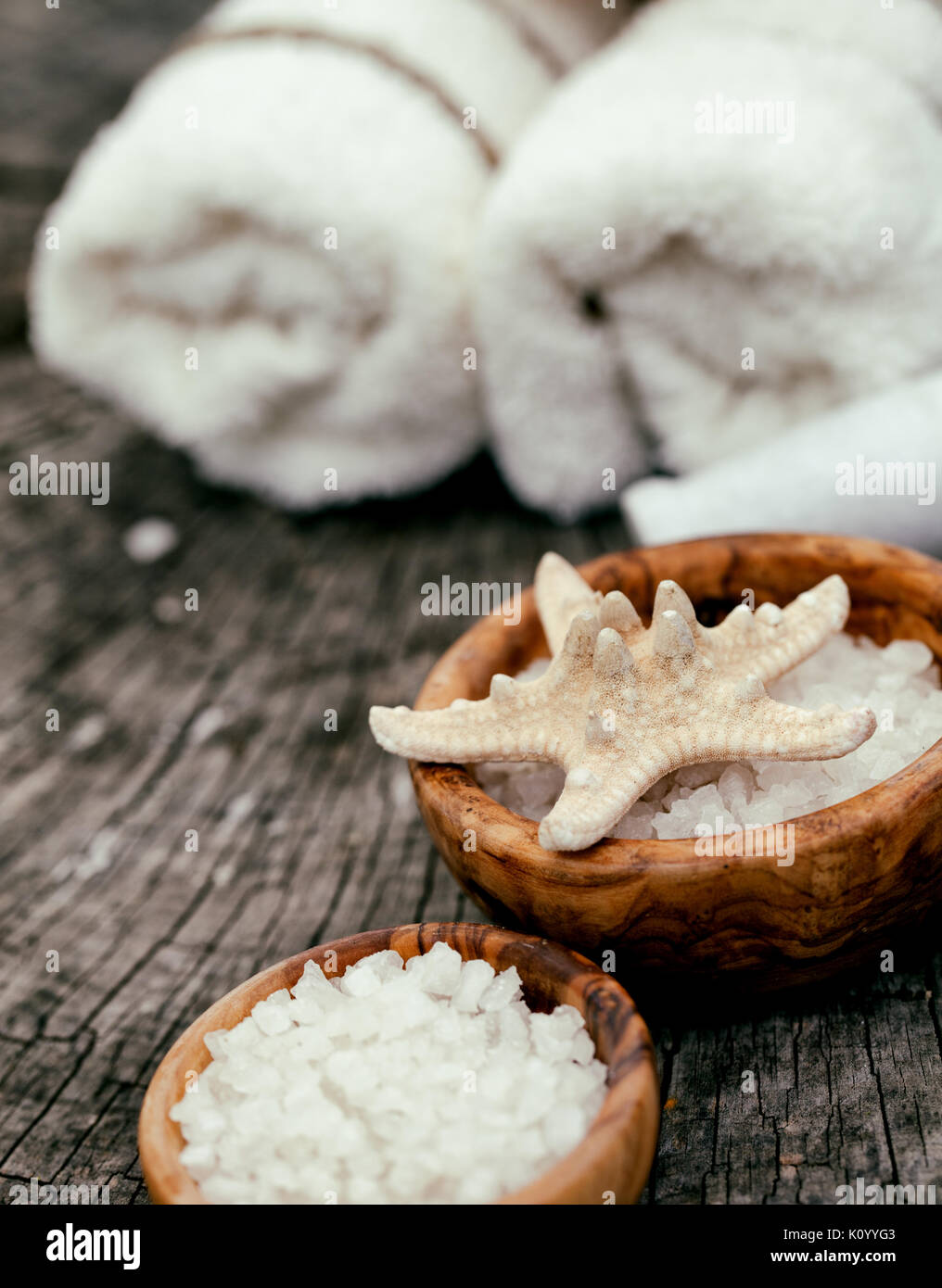 Spa and wellness setting with flowers, floral water and towel. Natural ...