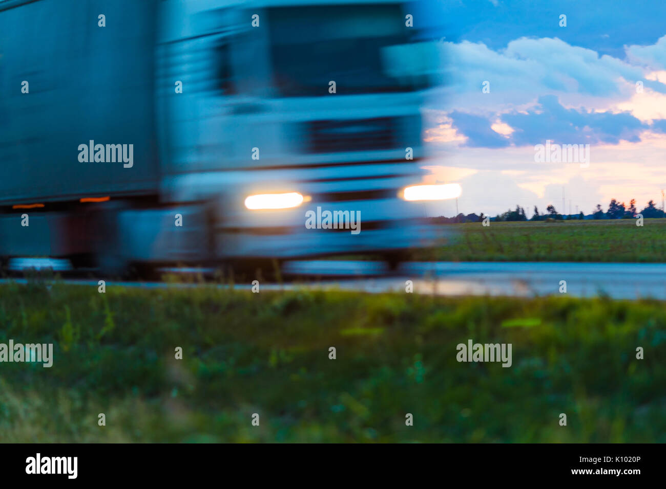 Speeding motion blur oncoming trucks with glowing lights on the highway ... Speeding motion blur oncoming trucks with glowing lights on the highway ...