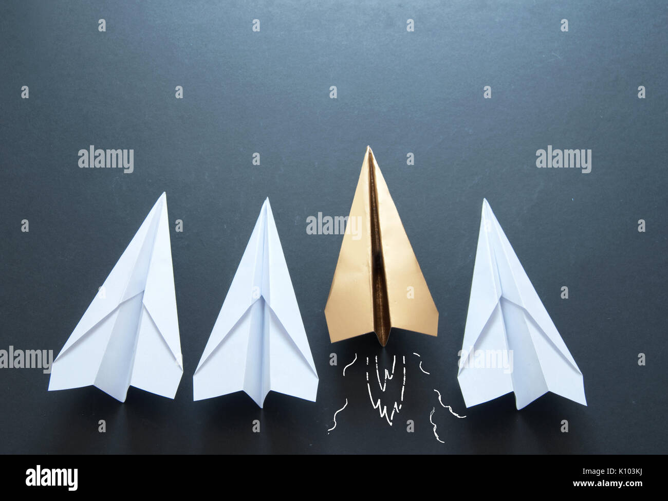 Gold paper plane standing out in a line Stock Photo - Alamy