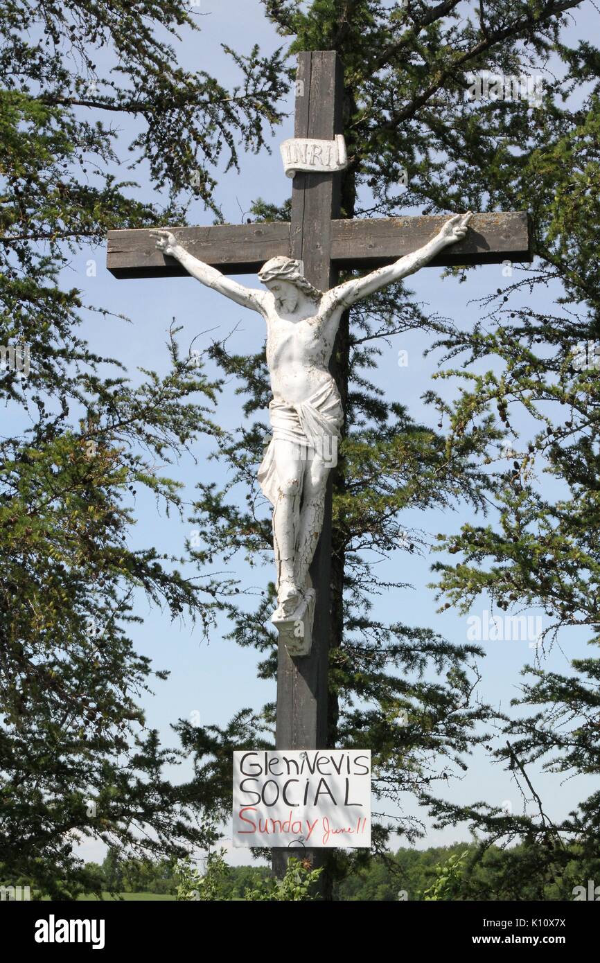 Outdoor cross in rural town with announcement Stock Photo - Alamy