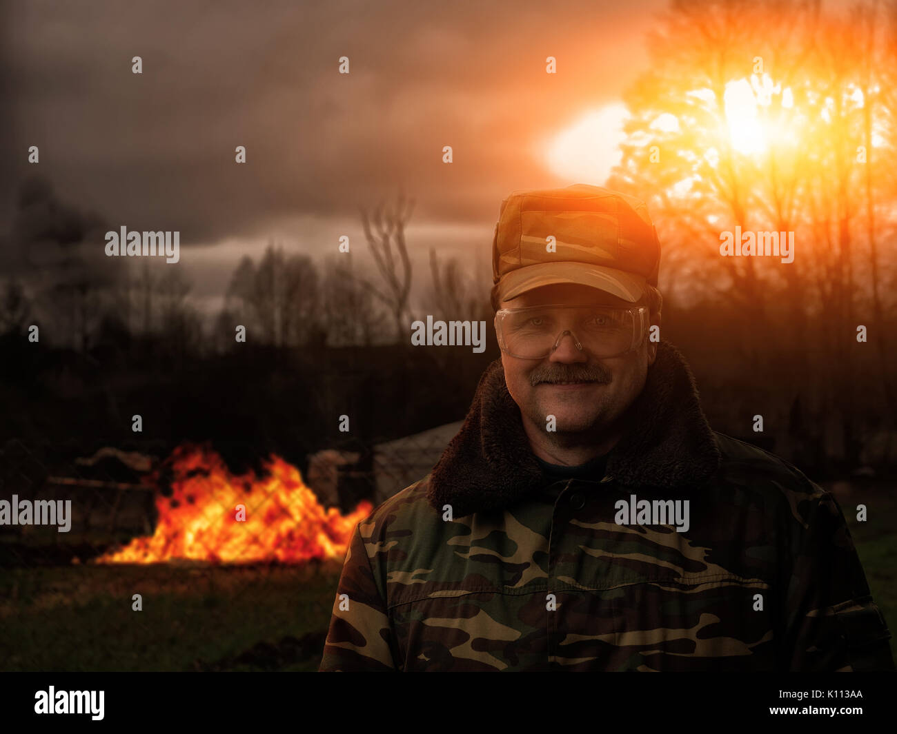 A man in uniform armed with a fire. Smile of the prankster. In the ...