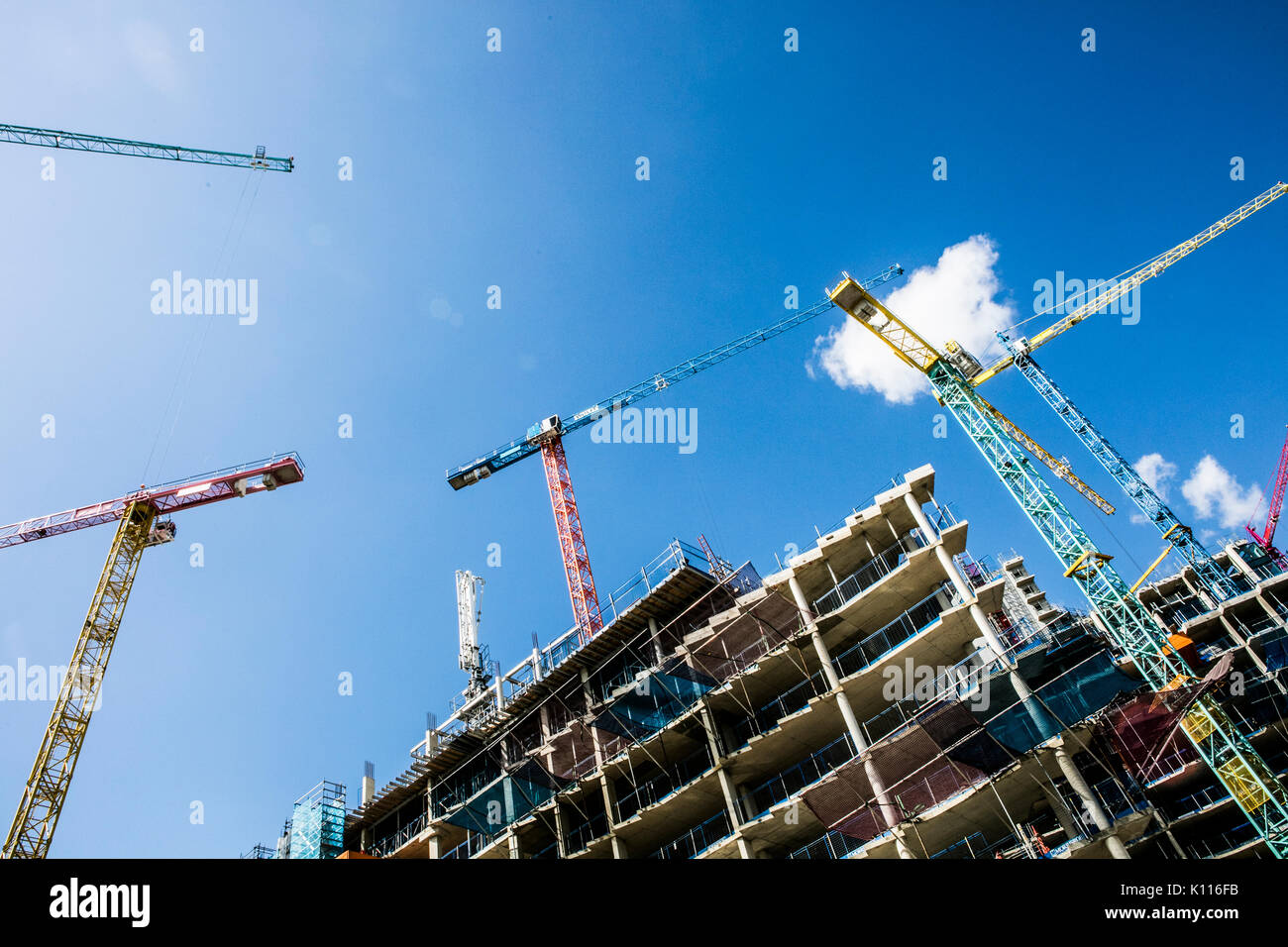 Cranes Building houseing Stock Photo - Alamy