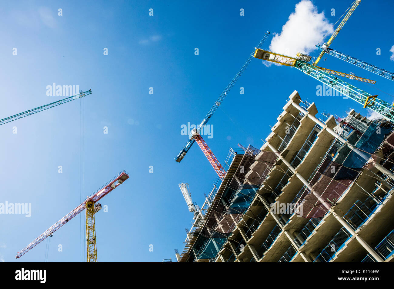 Cranes Building houseing Stock Photo - Alamy