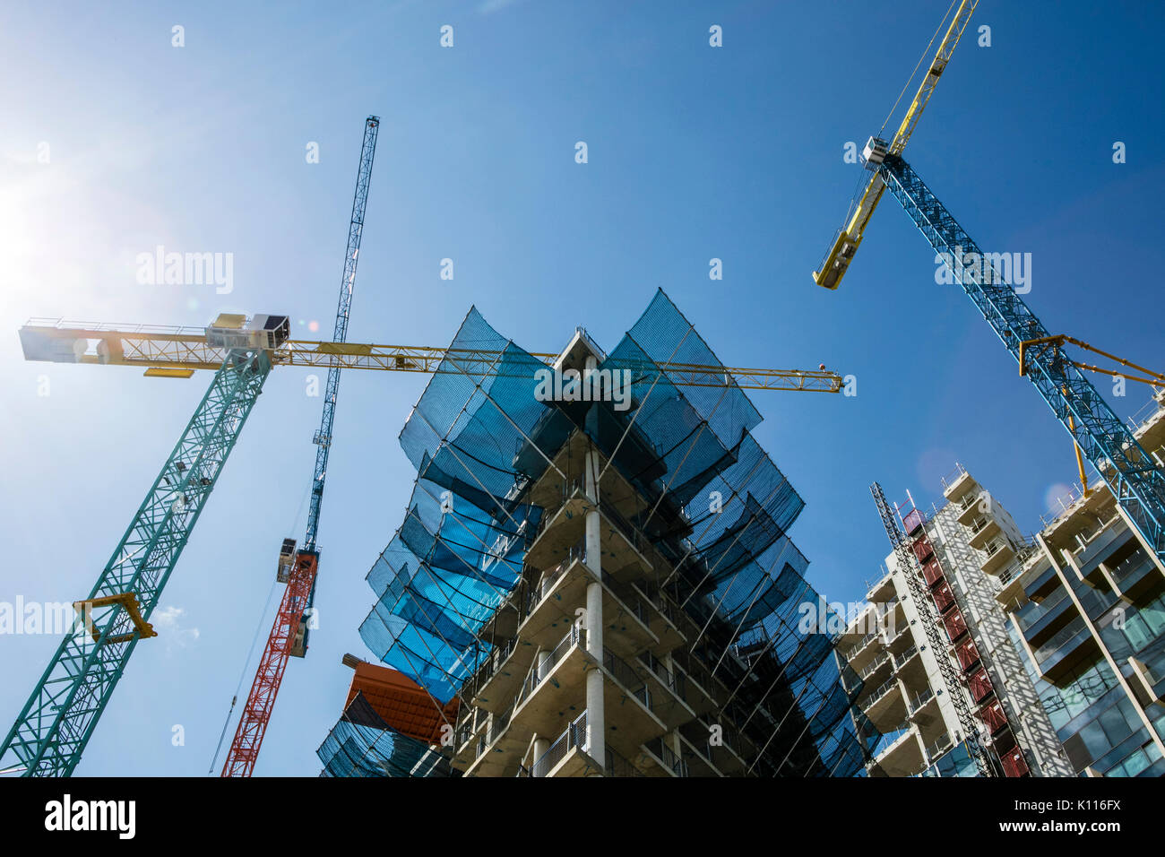 Cranes Building houseing Stock Photo - Alamy