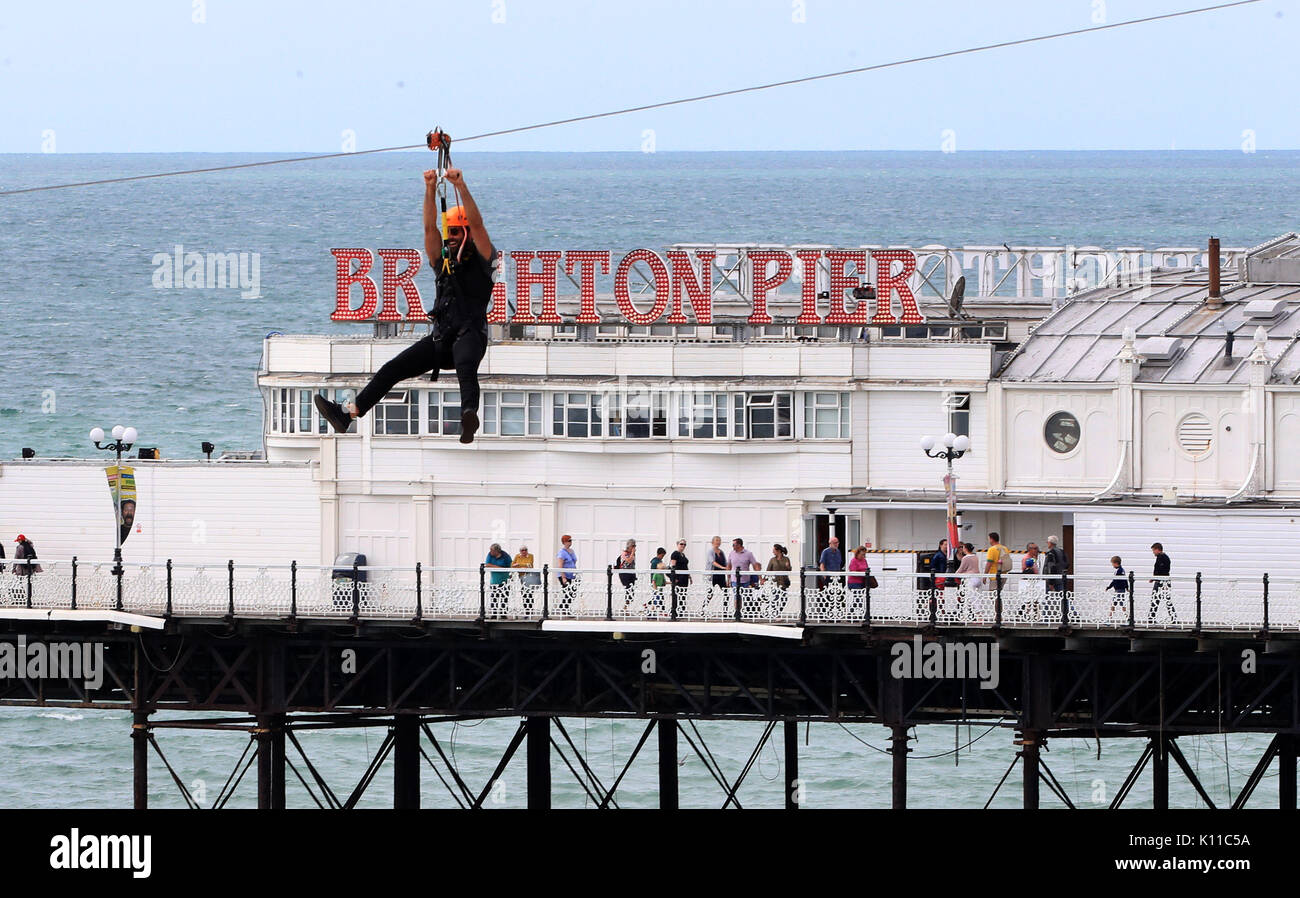 A man enjoys a ride on the Brighton Zip during the warm weather in ...