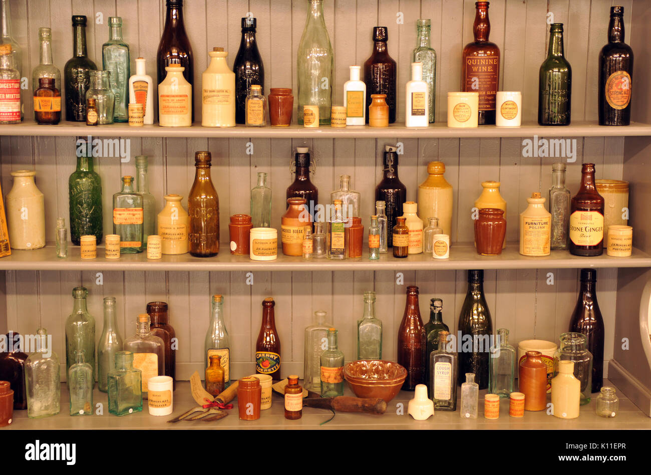 Rows of old jars and bottles on a shelf a complete collection of ...