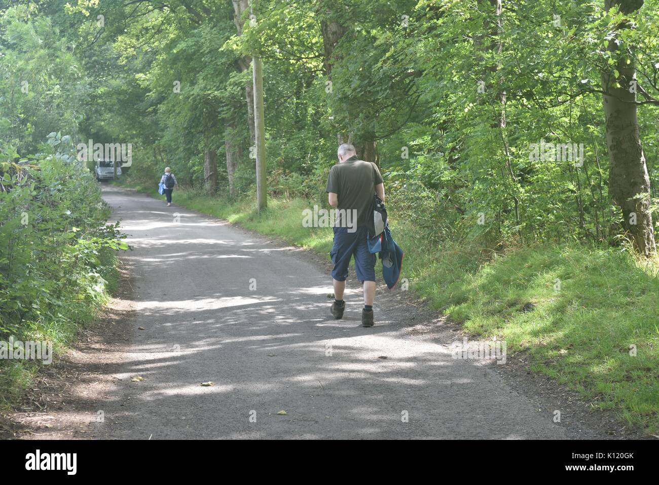 Man walking down country lane hi-res stock photography and images - Alamy