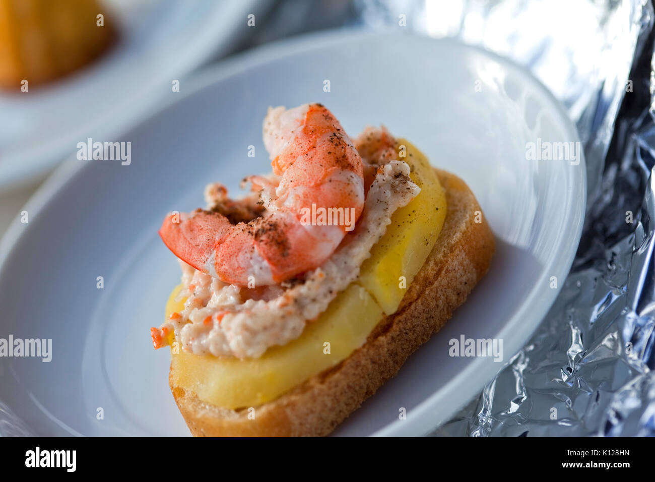 Shrimp, seafood mousse and slice of potato on a toast Stock Photo - Alamy
