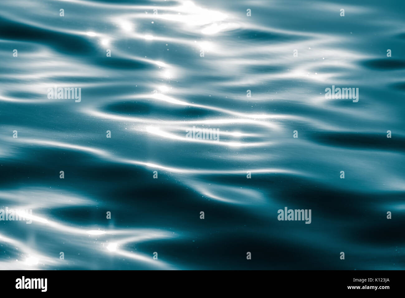 Water surface with moving wave of blue water reflecting light Stock ...
