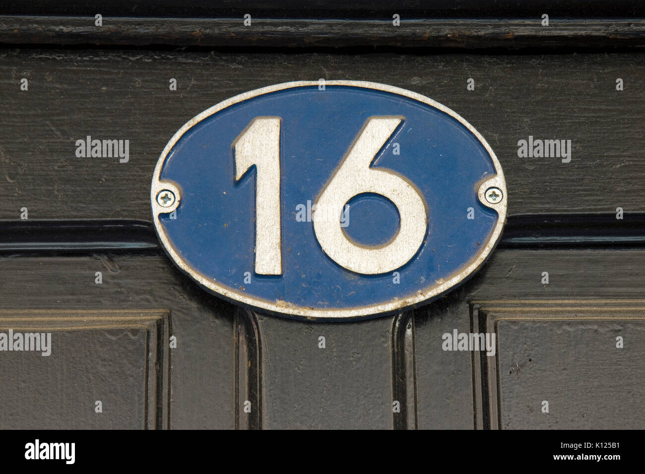 Enameled blue and white number 16 on wooden door Stock Photo - Alamy