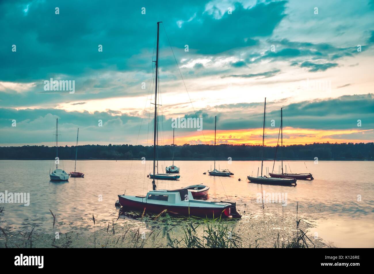 Summer evening landscape. Boats on the lake and colorful sky Stock ...