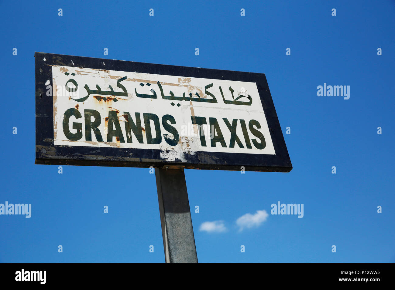 A sign for multi-passenger taxis "grands taxis" is displayed in arabic ...
