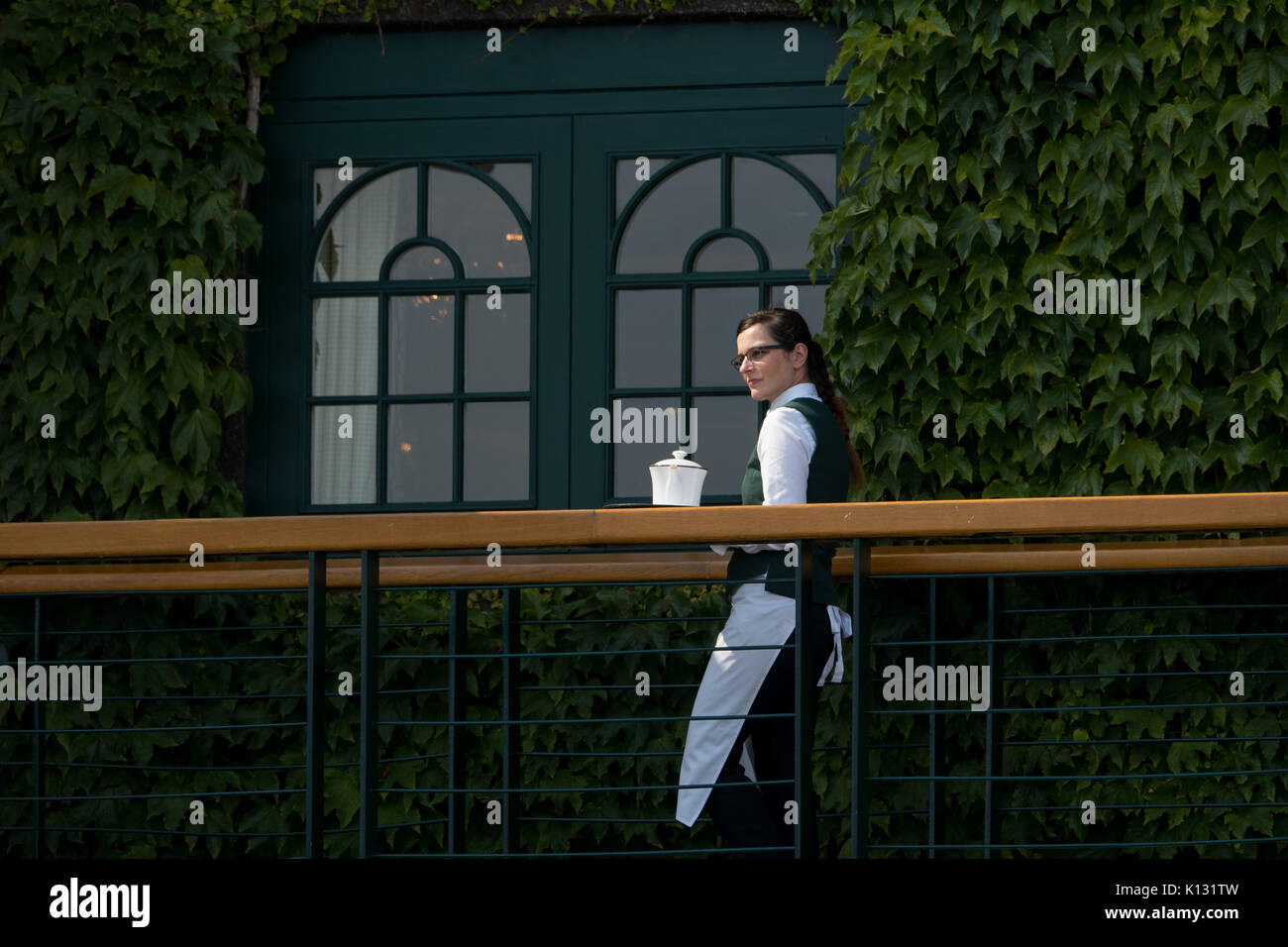 A waiter walks past a window at the members enclosure in Centre Court ...