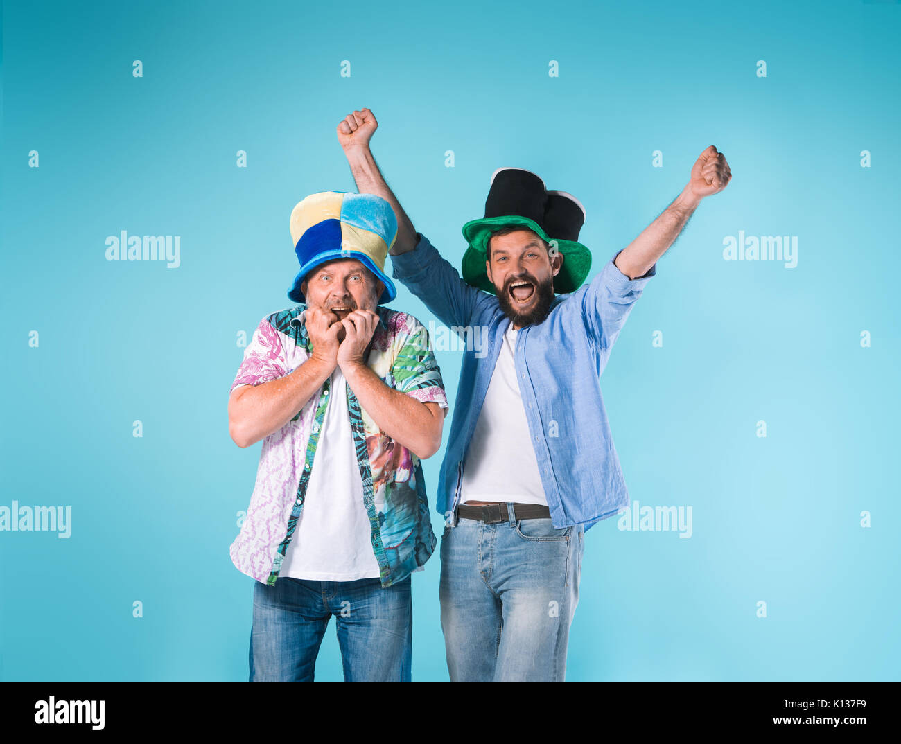 The two football fans over blue Stock Photo - Alamy