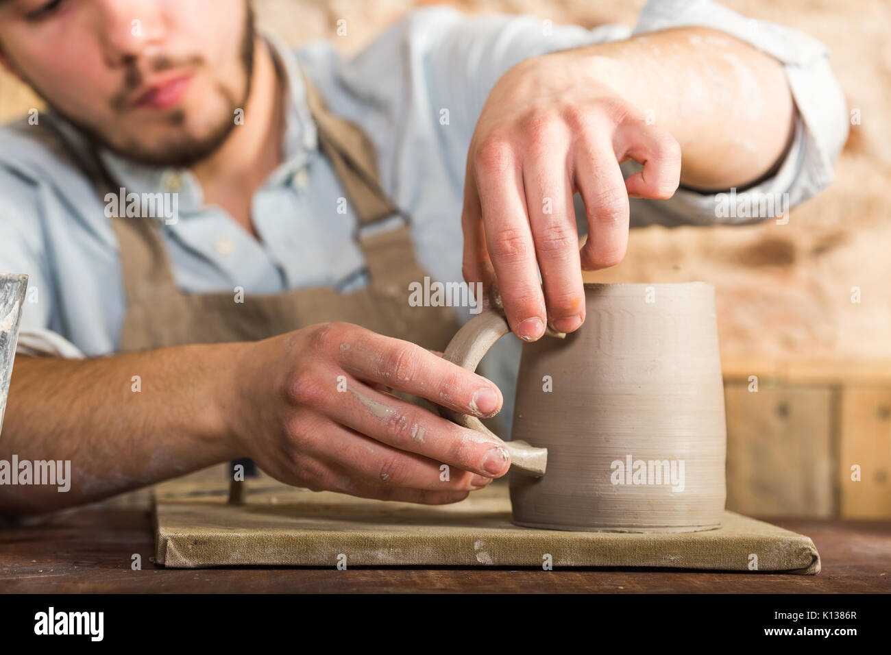 potter, stoneware, ceramics art concept - craftsman's hands connect the ...