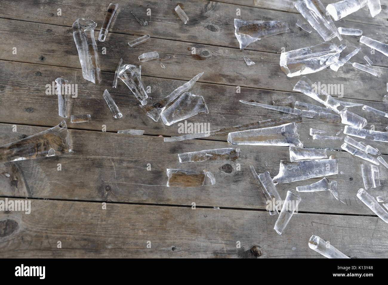 Smithereens of shattered thin icicles lay melting scattered across a ...