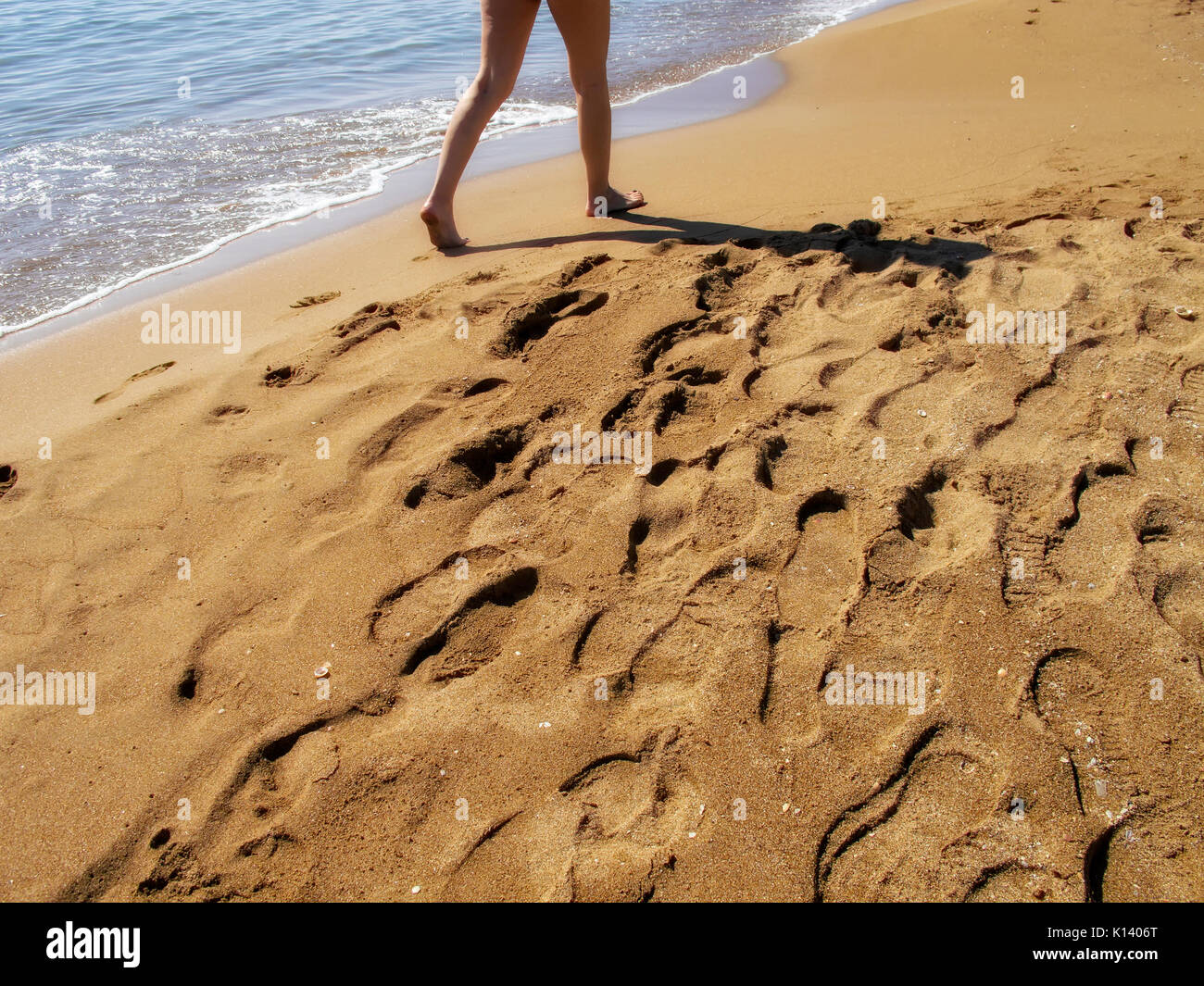 close up young adult woman walking on sandy beach Stock Photo - Alamy