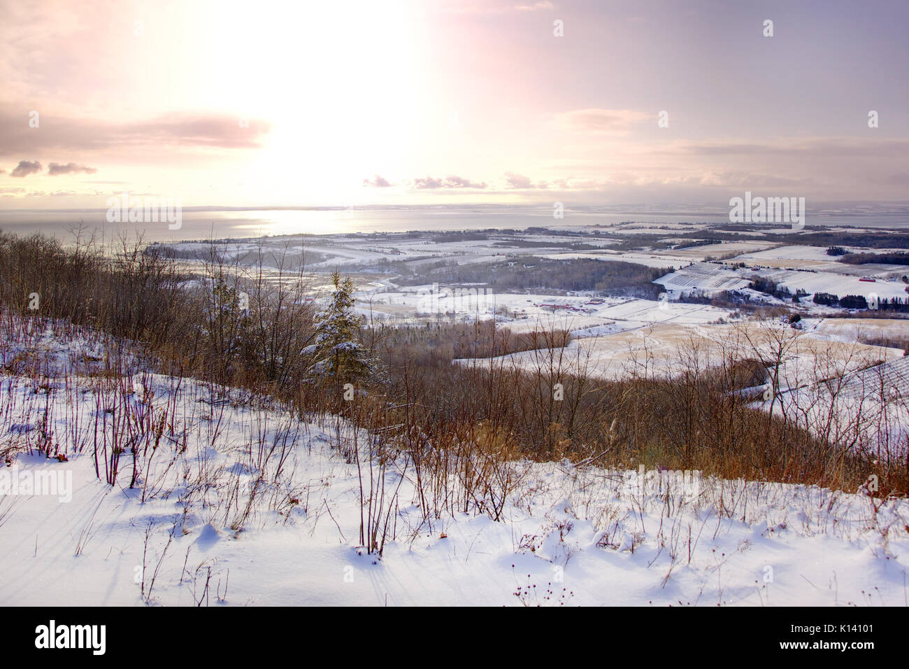 View from the top of a hill in winter with sunrise and snow Stock Photo ...