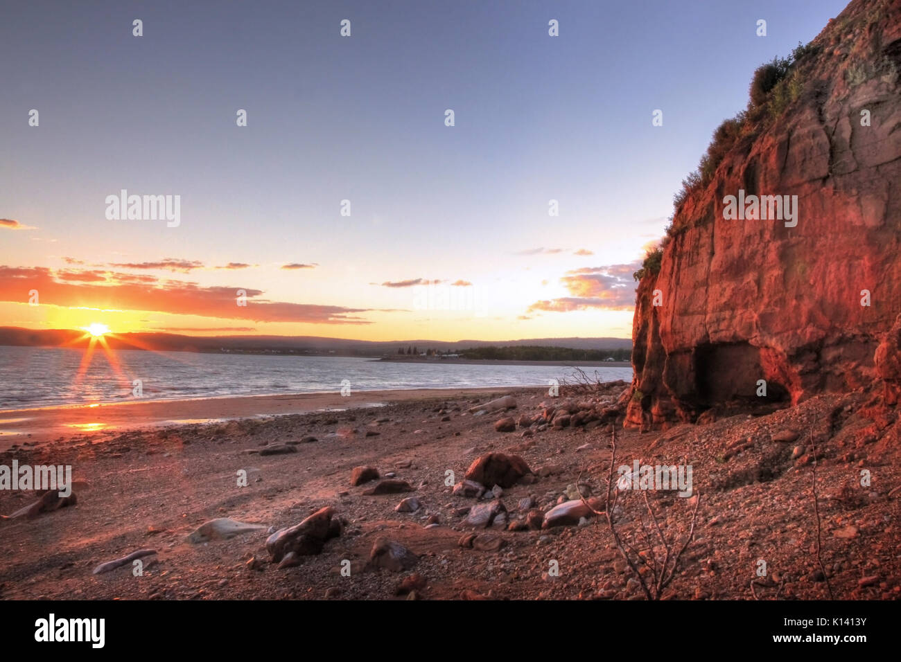 Red rocky cliffs by the ocean in Nova Scotia Stock Photo - Alamy