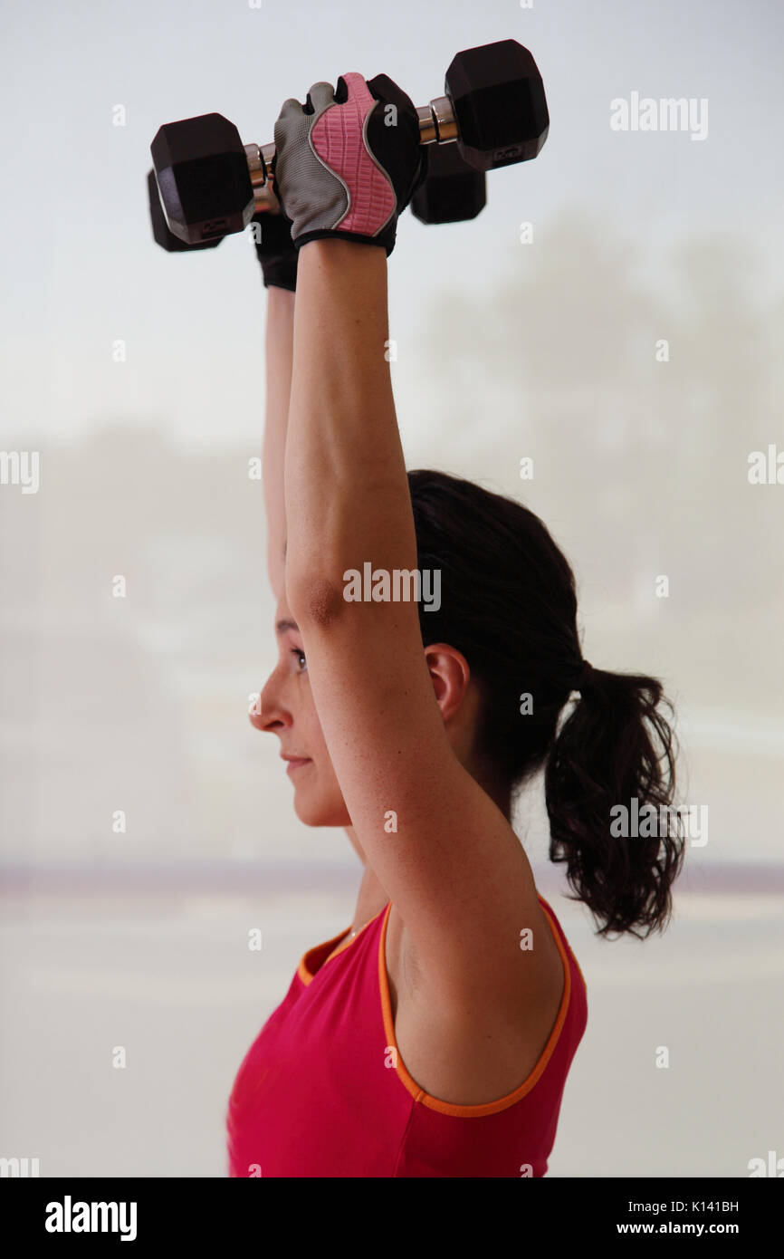 athletic woman lifts weights Stock Photo - Alamy