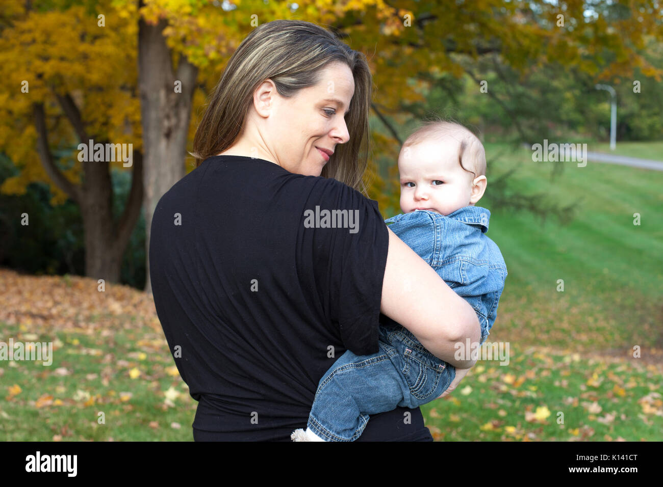 Mother carrying child over shoulder hi-res stock photography and images ...