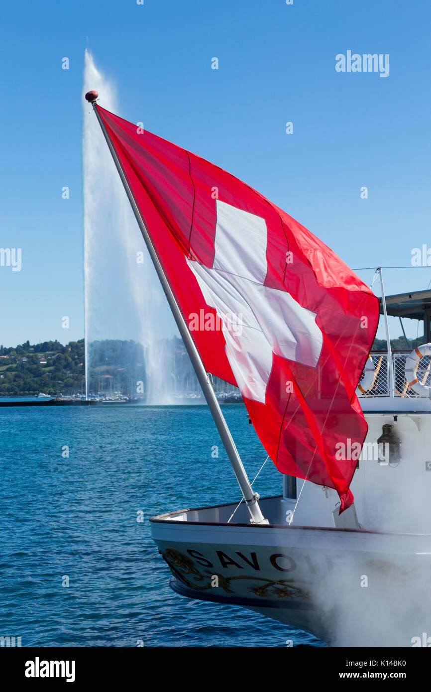 The Swiss flag, flag of Switzerland, flying over the lake in front of ...