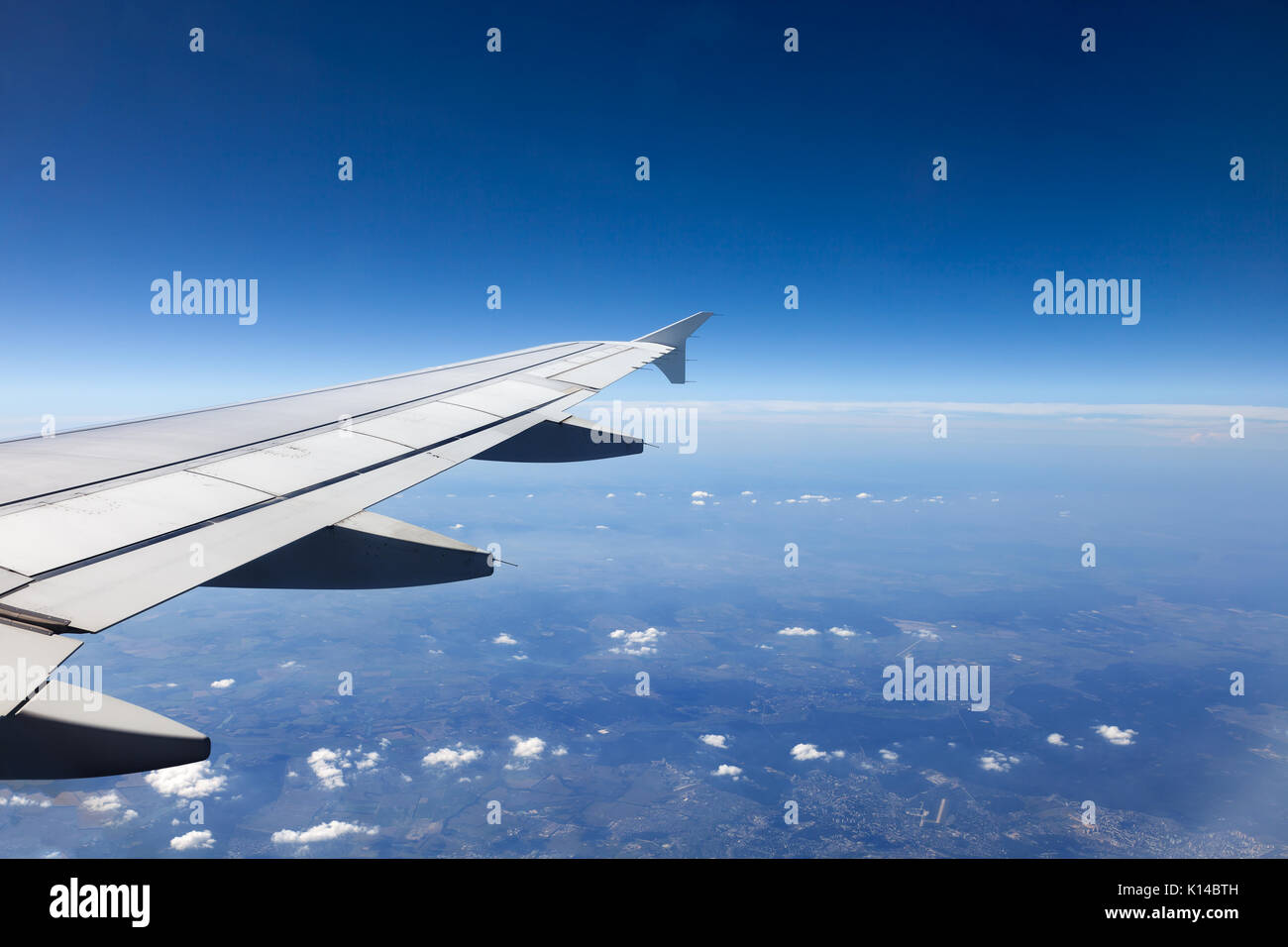 Wing of aircraft view from airplane window Stock Photo - Alamy