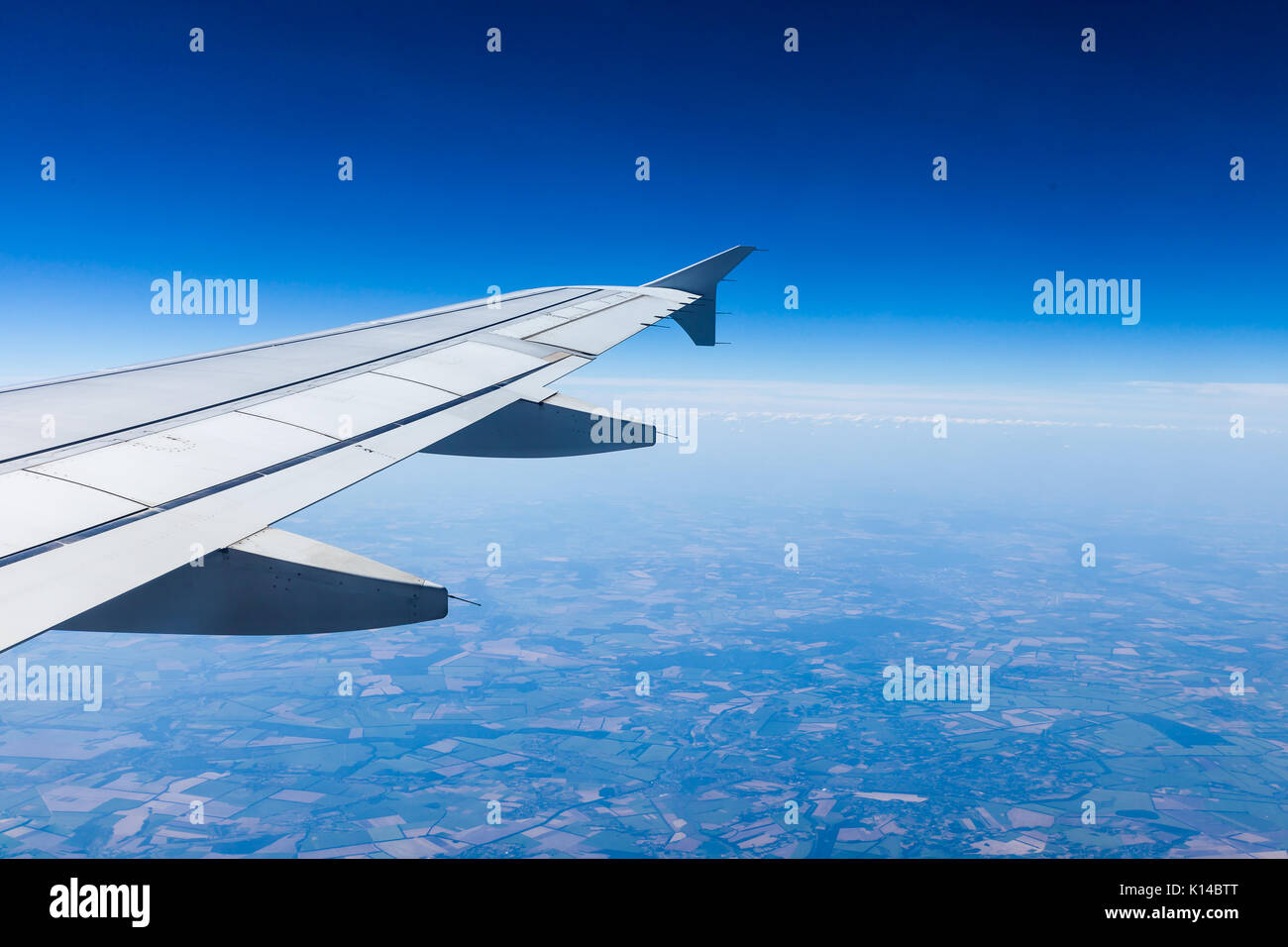 Wing of aircraft view from airplane window Stock Photo - Alamy