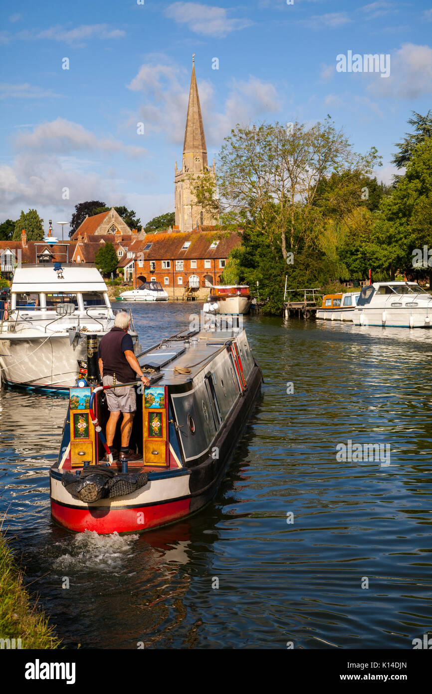 Narrowboat owner leaving his overnight mooring on the river Thames at ...