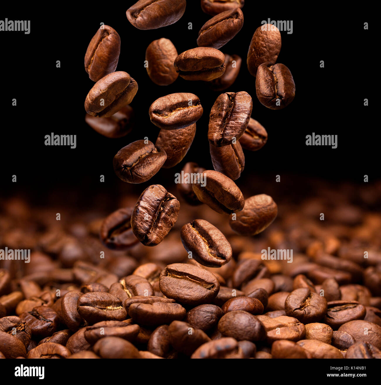 Falling coffee beans on dark background Stock Photo - Alamy