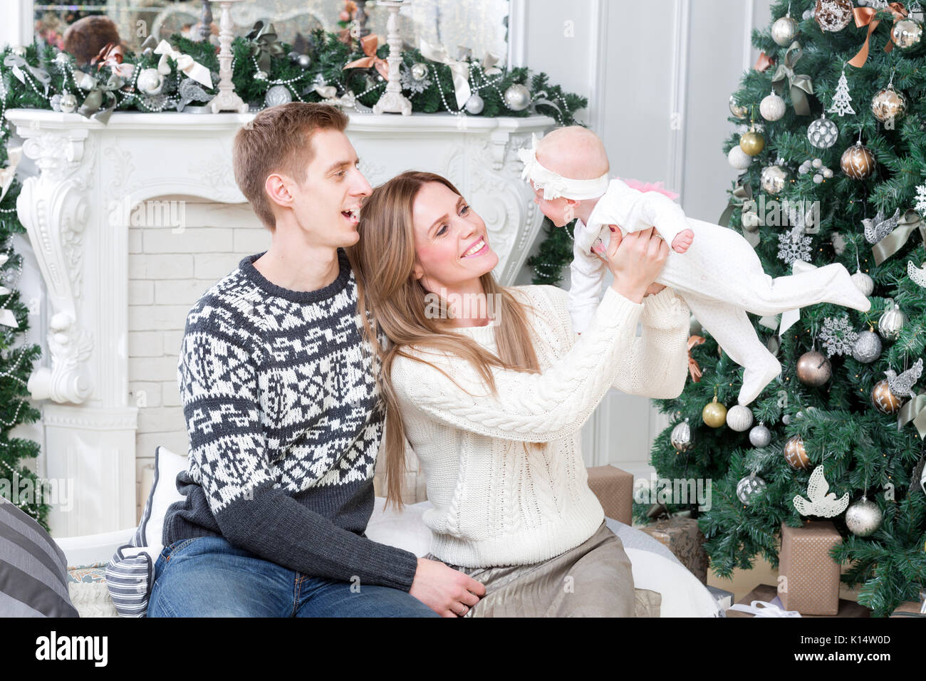 Happy family in Christmas morning in home. Christmas tree on the ...