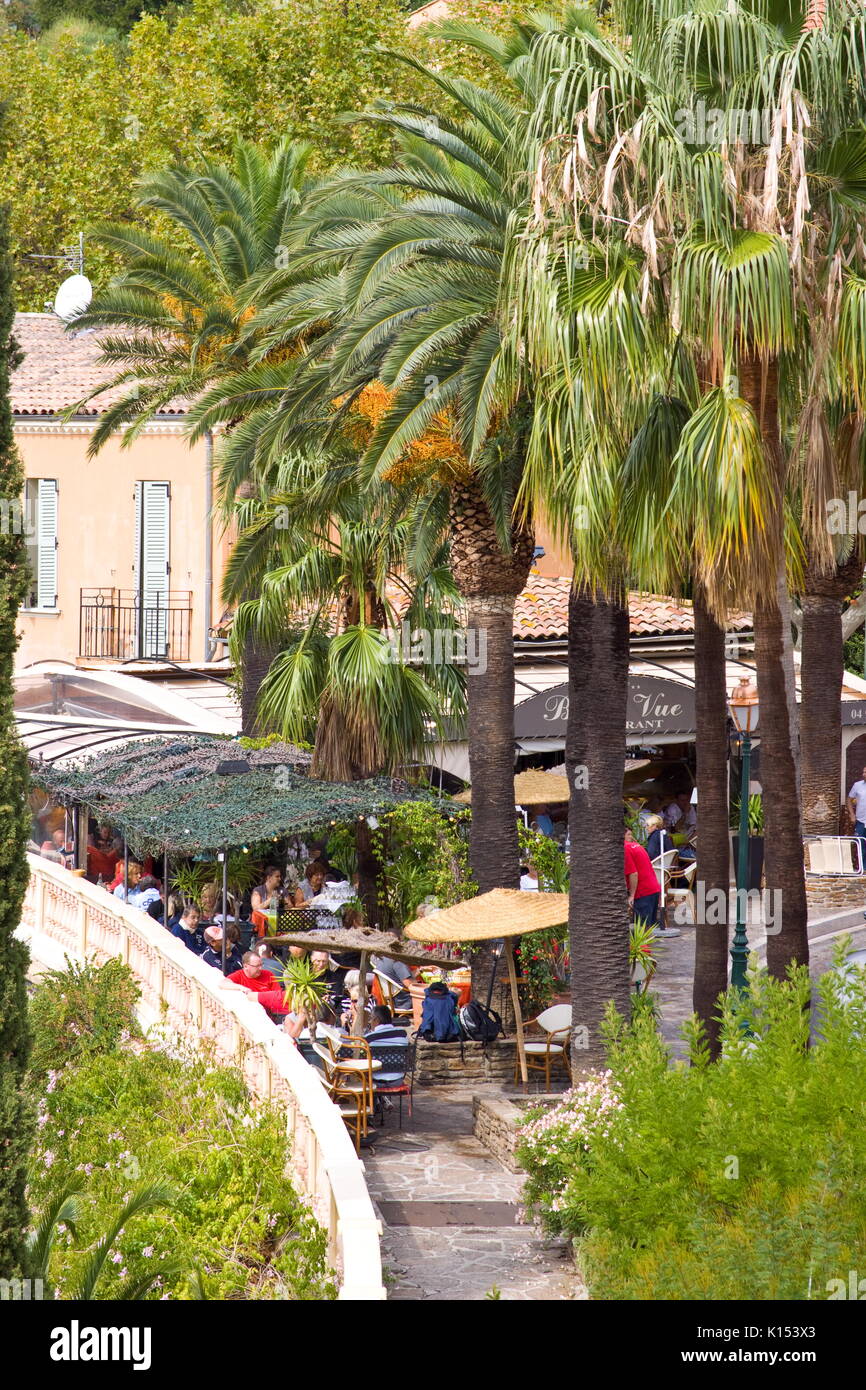 Cafes and people in tree lined streets in Bormes les Mimosas Cote d ...