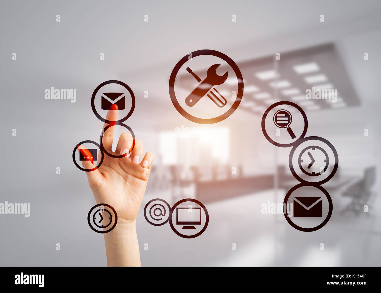 Modern office interior and close of businesswoman hand choosing symbol ...
