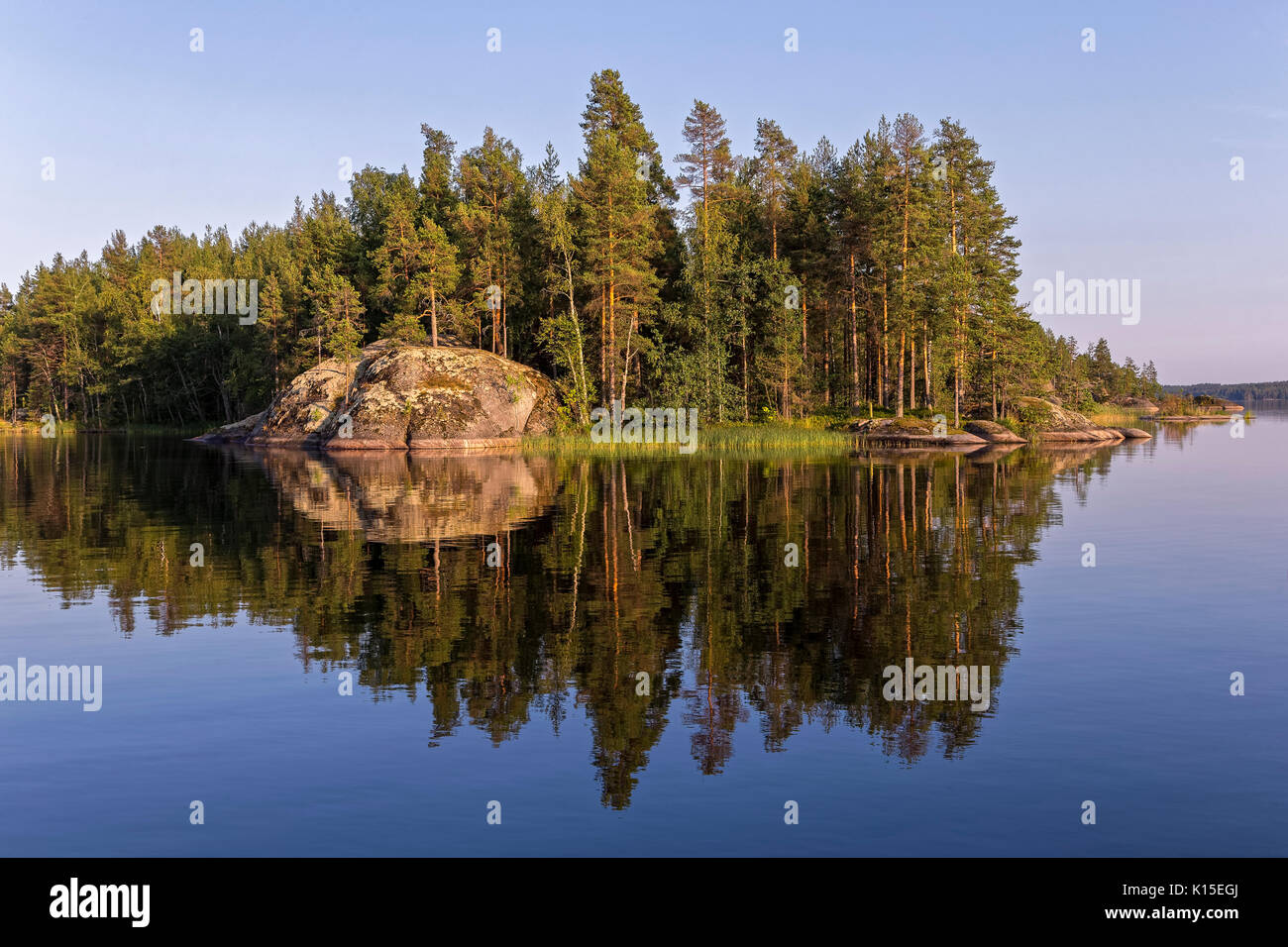 Reflection Trees and rocks, lake, Kokonsaari, Finland Stock Photo - Alamy