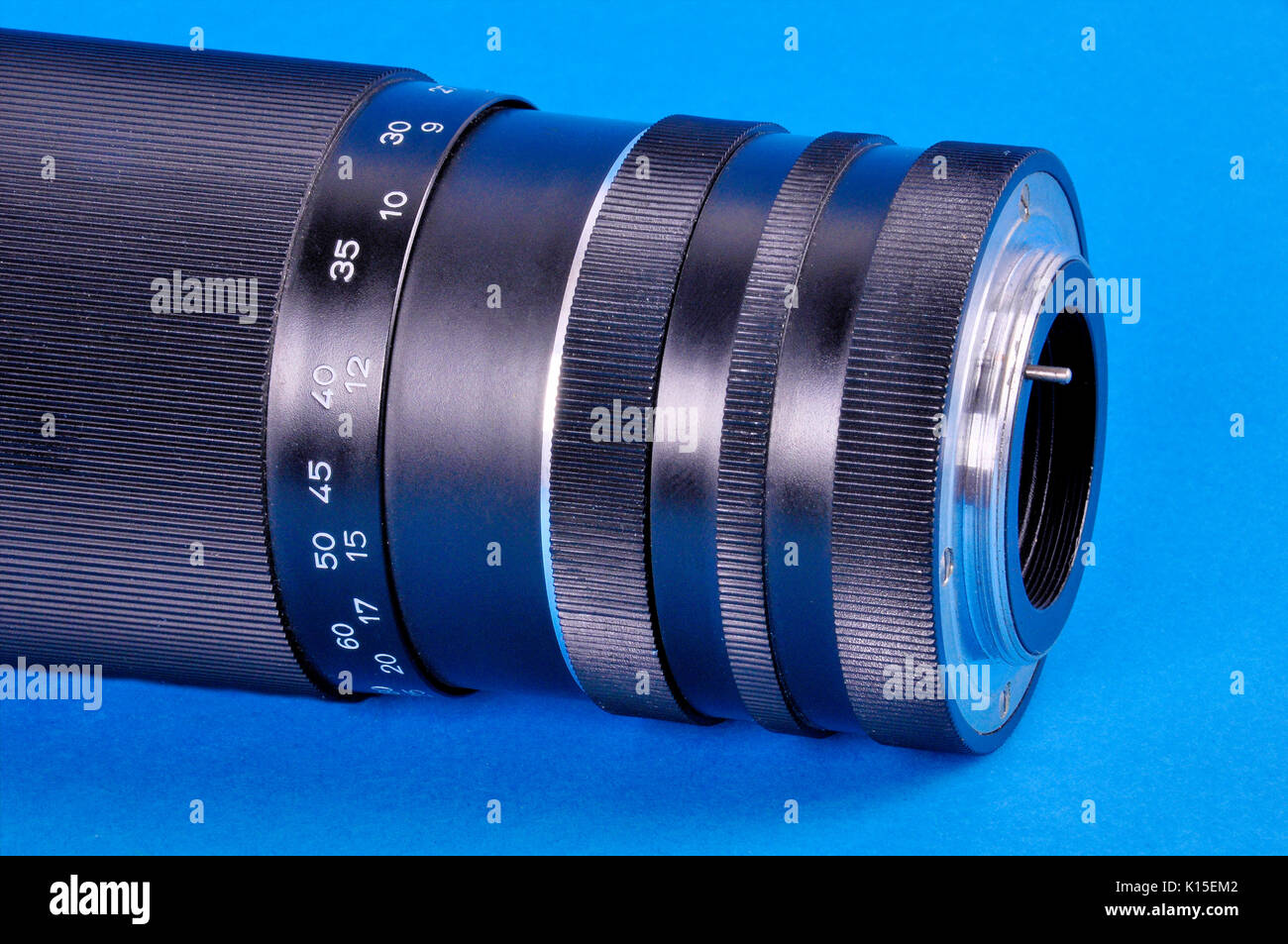 Old manual lens on a blue background Stock Photo - Alamy