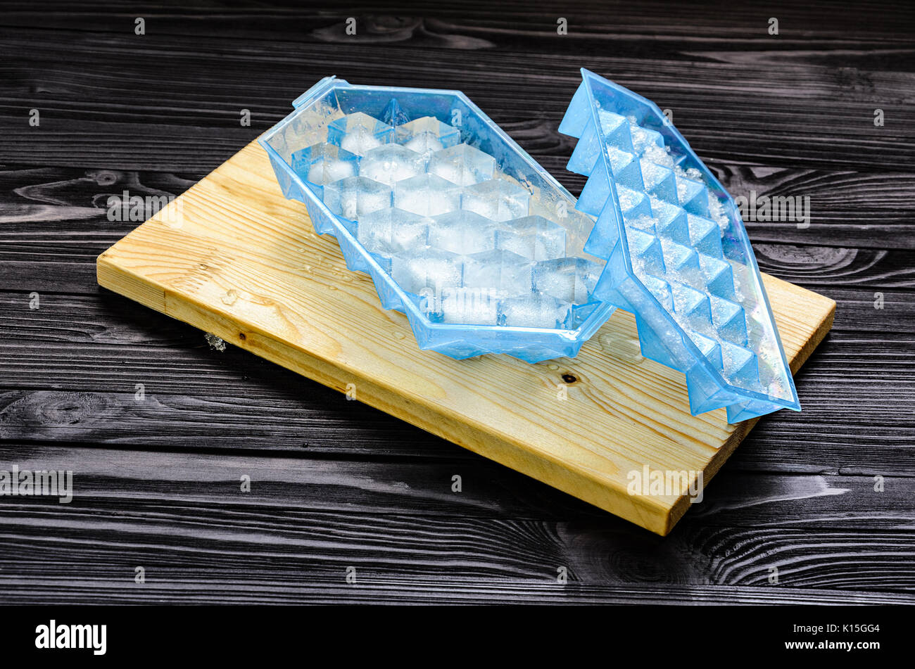 A blue plastic ice cube tray with ice cubes Stock Photo - Alamy