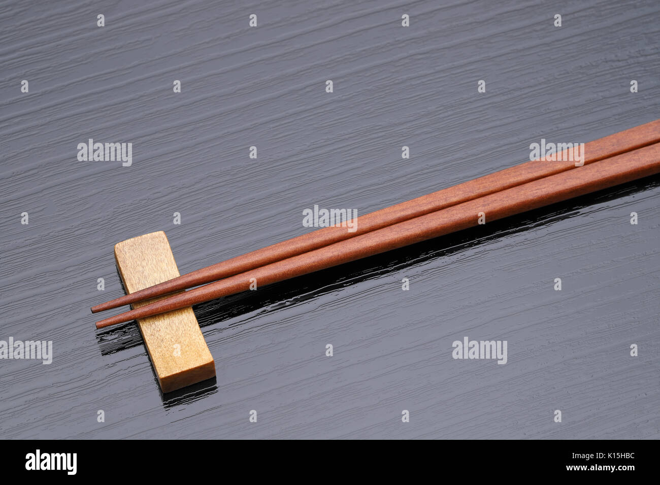 Chopsticks and chopsticks rest on black table background Stock Photo ...