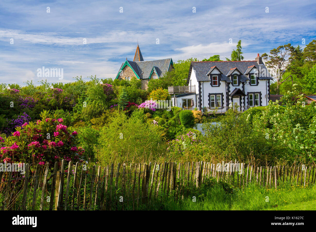 Black and white house with colourful garden at Scottish town of Oban ...