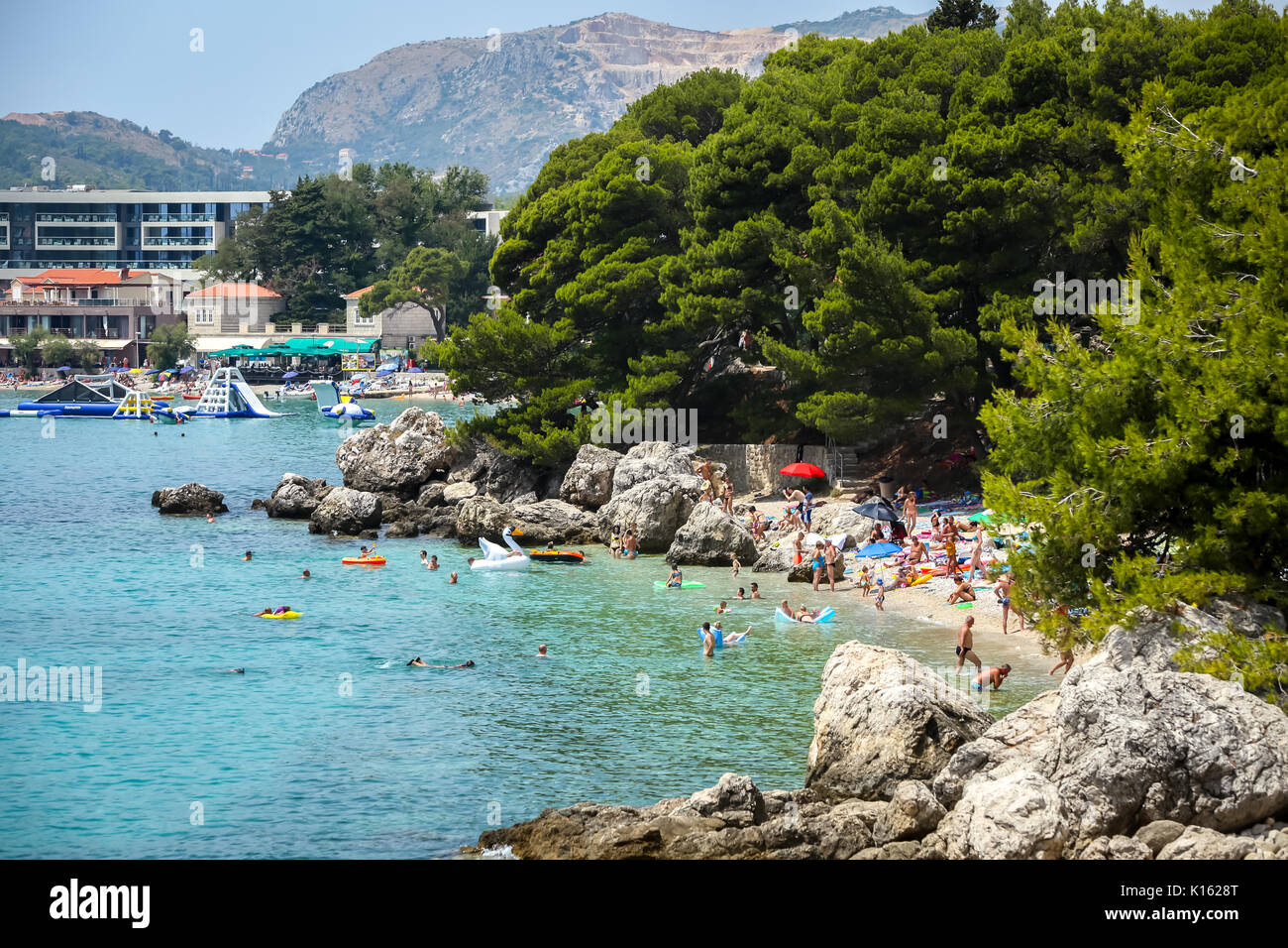 MLINI, CROATIA - JULY 22, 2017 : People bathing and sunbathing on sea ...