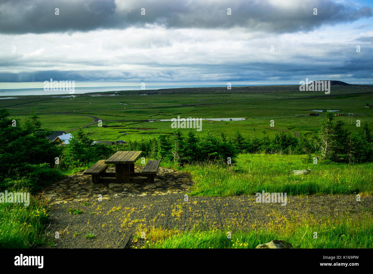 Picnic Table and rest area on a cliff overlooking a cloudy landscape ...