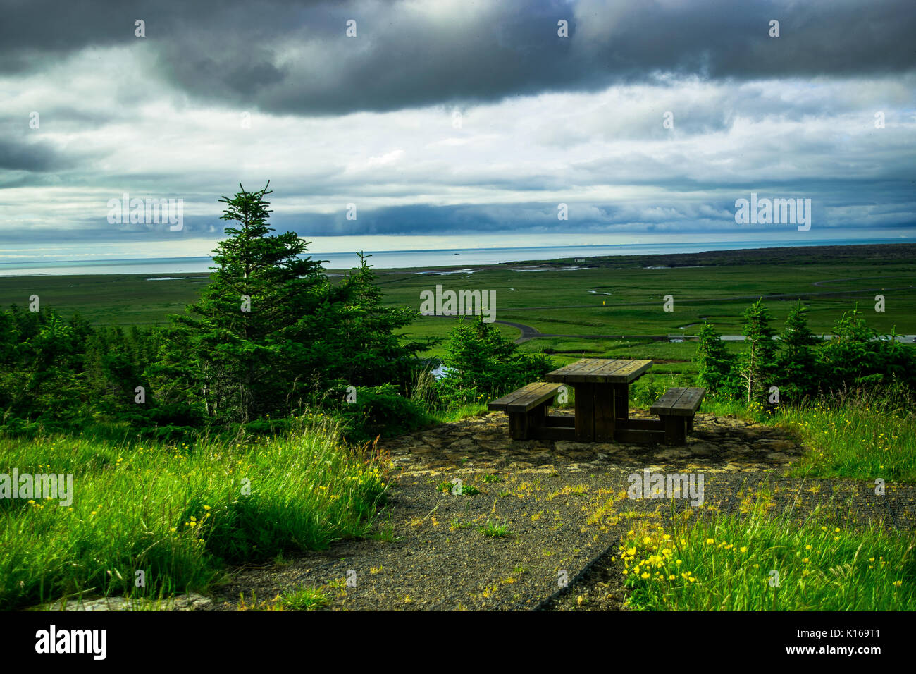 Picnic Table and rest area on a cliff overlooking a cloudy landscape ...