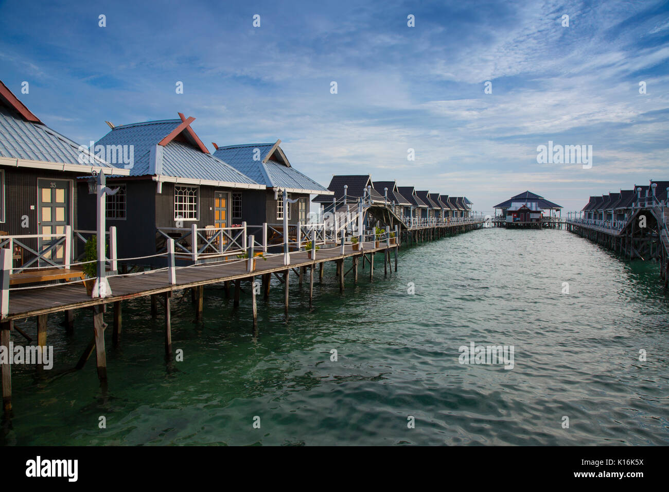 Tourist bungalows over the ocean at Billabong Dive Resort, Mabul Island ...