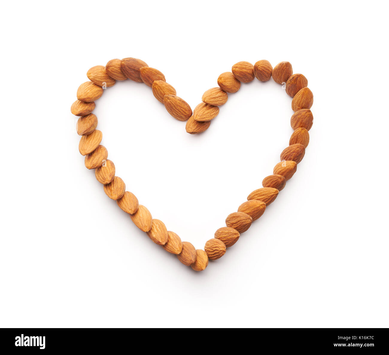 Almond nuts forming a heart-shape isolated on white Stock Photo - Alamy