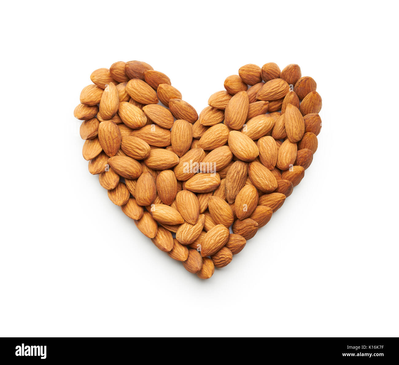 Almond nuts forming a heart-shape isolated on white Stock Photo - Alamy