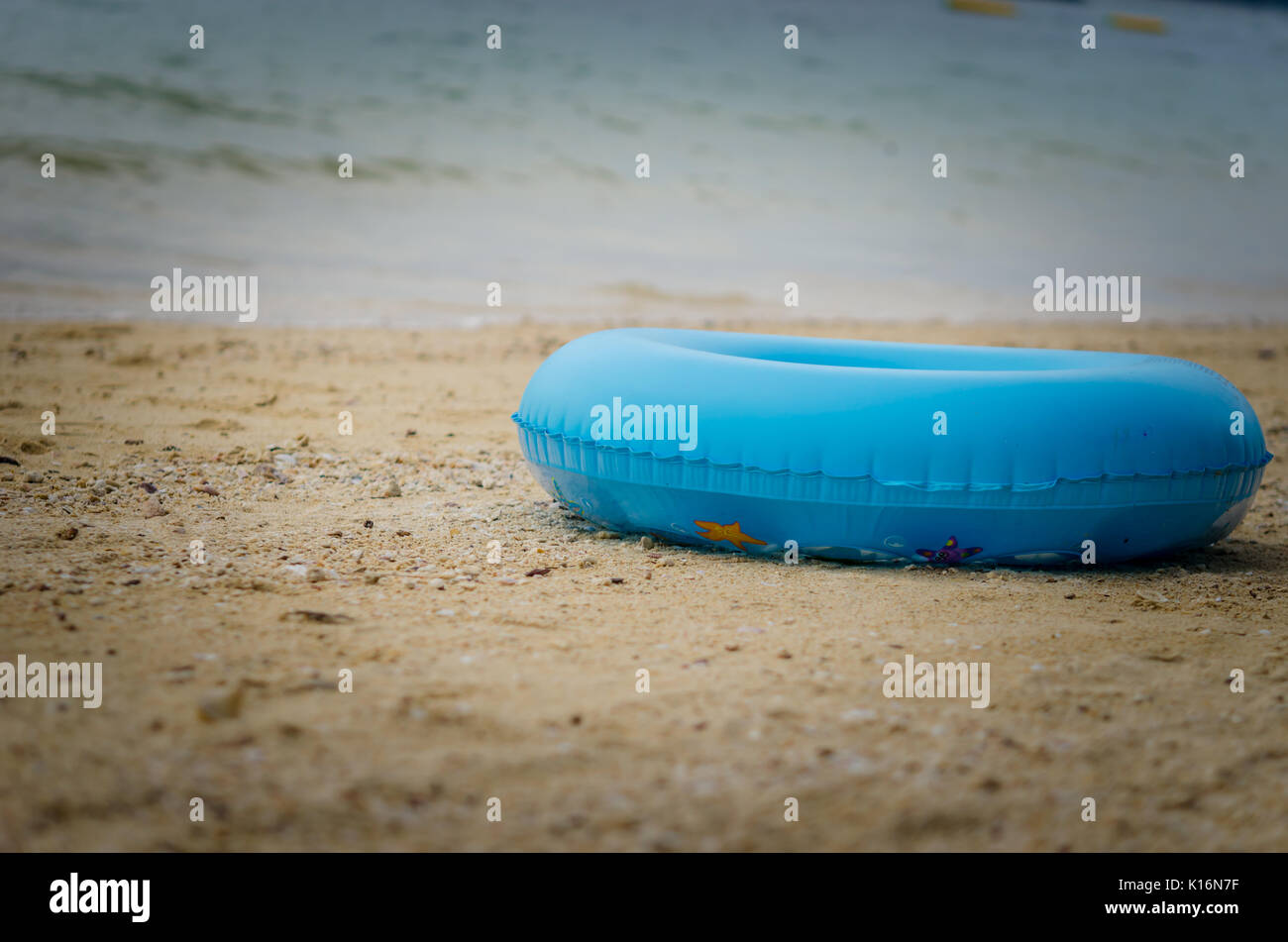 rubber ring on beach by the sea Stock Photo - Alamy