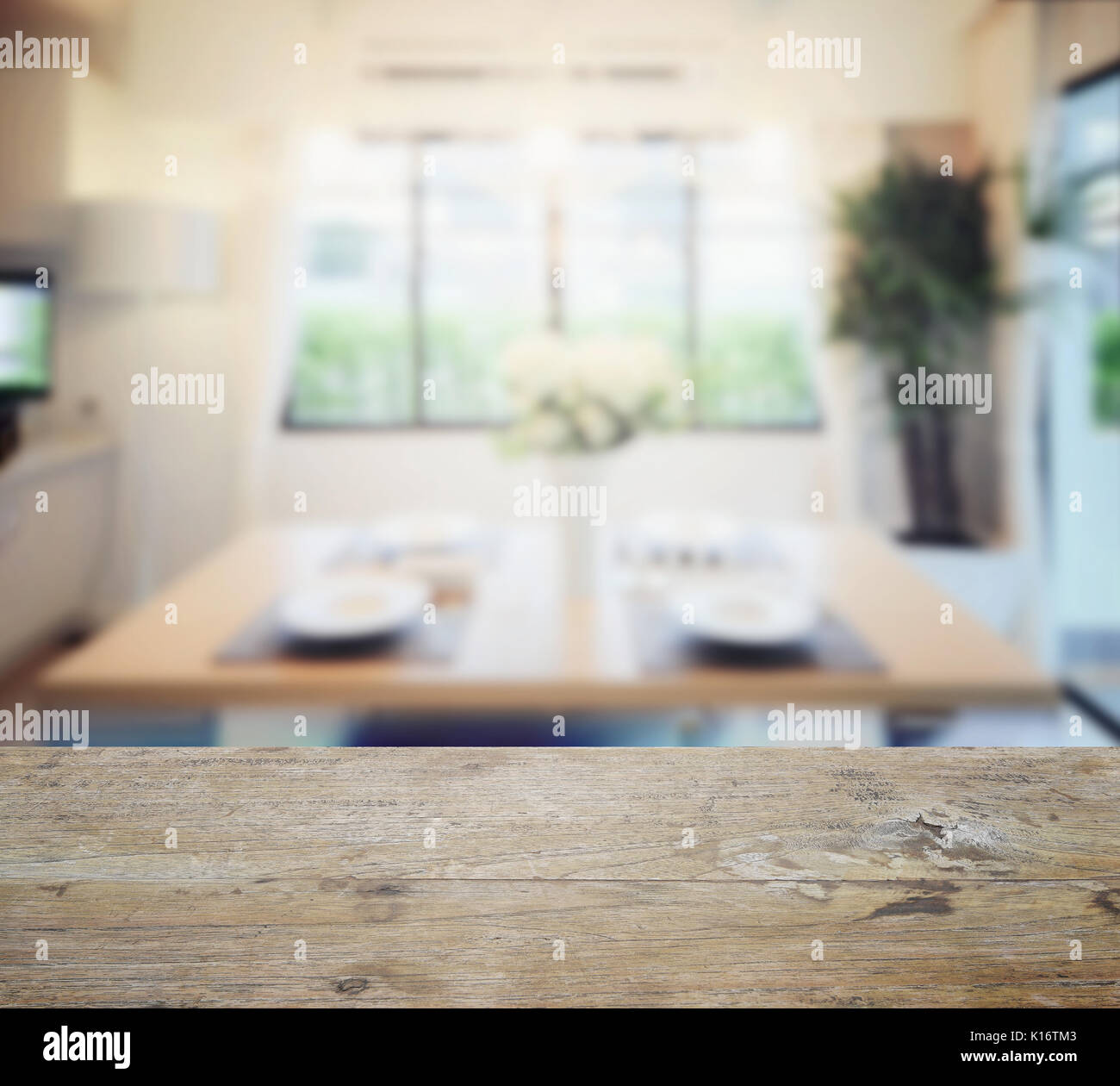 wooden table top with blur of modern dining room interior Stock Photo ...