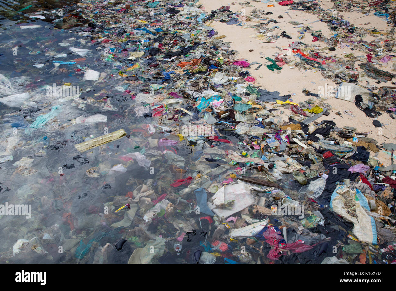 Plastic trash and other garbage covering sandy beach Stock Photo - Alamy