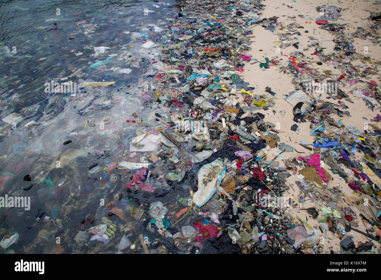 Plastic trash and other garbage covering sandy beach Stock Photo - Alamy