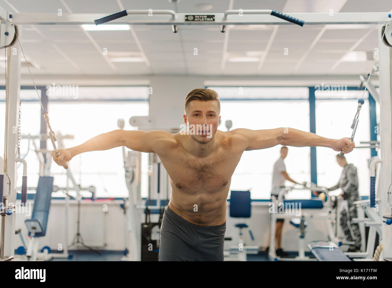 attractive man training on Fitness-station. Man with six-pack abs and ...